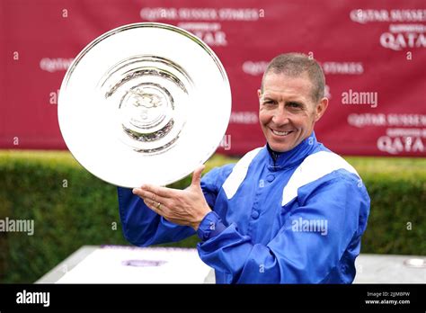 Jockey Jim Crowley Celebrates With The Trophy After Winning The Qatar