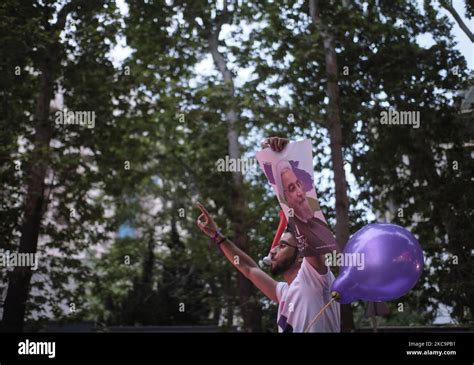 An Iranian Man Holds Up A Portrait Of Irans President Hassan Rouhani As Celebrates Reformist