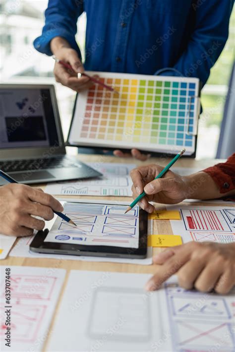 the web ux ui design team is writing code and layers to customize the smartphone front ux ui