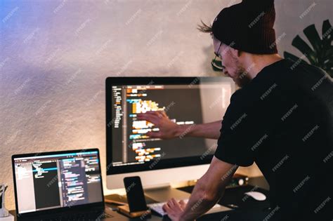 Premium Photo Young Man Mobile Developer Writes Program Code On A Computer Programmer Work In