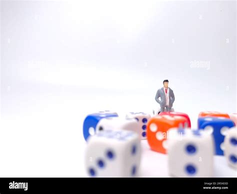 a human figurine is surrounded by a vibrant array of colorful dice