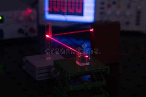 Experiment In Optic Lab With Laser Device Red Laser On Optical Table In Physics Laboratory