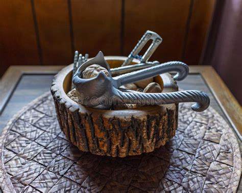 A Bowl Of Walnuts Still In The Shell In A Bowl With Several Tools For Cracking Them Stock Image