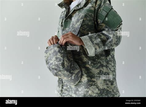 A Dedicated Female Soldier Adjusts Her Gear Showcasing Pride In Her