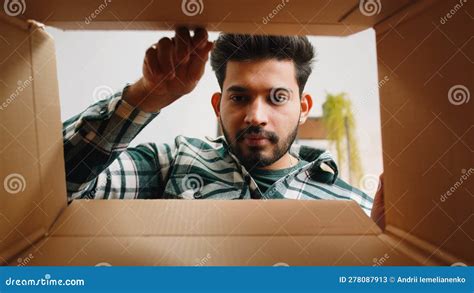Happy Indian Man Shopper Unpacking Cardboard Box Delivery Parcel Online