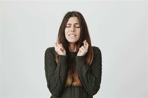 Free Photo Worried Young Cute Woman Making Wish With Closed Eyes And