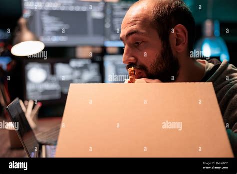 Database Coder Eating Pizza From Takeaway Delivery Taking Bite Of Food
