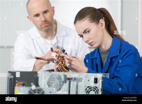 Attentive Female Technician Fixing Cables Stock Photo Alamy