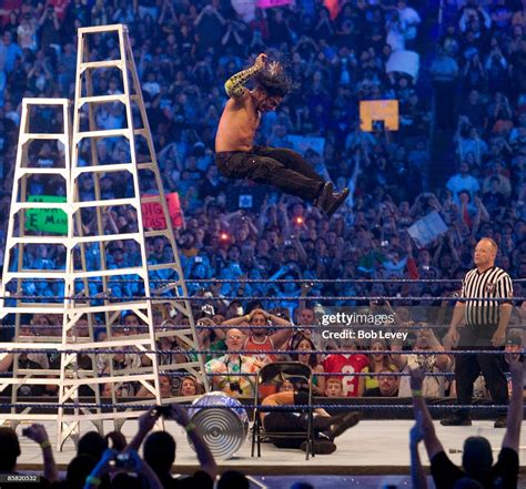 Jeff Hardy Leaps Off A Ladder Onto The Body Of Brother Matt During An