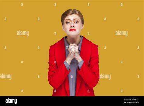 Portrait Of Hopeful Woman With Red Lips Standing With Hands Together