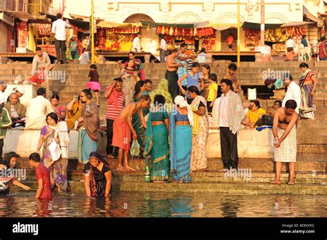 Devotees On The Banks Of The River Ganges Take A Holy Dip In Varanasi