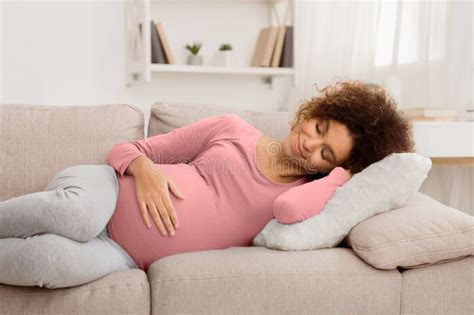 Happy Pregnant Woman Napping On Sofa Having Sweet Day Dream Stock