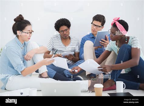 Young Creative Team Brainstorming Together In Creative Office Stock