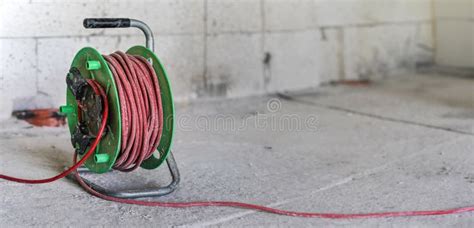 Red And Green Power Cord Extension Lead Drum On Construction Site