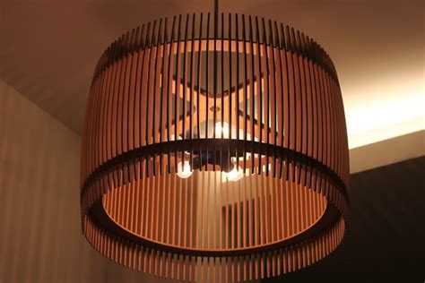 Beautiful round light fixture set in a hallway. Made out of laser cut ...