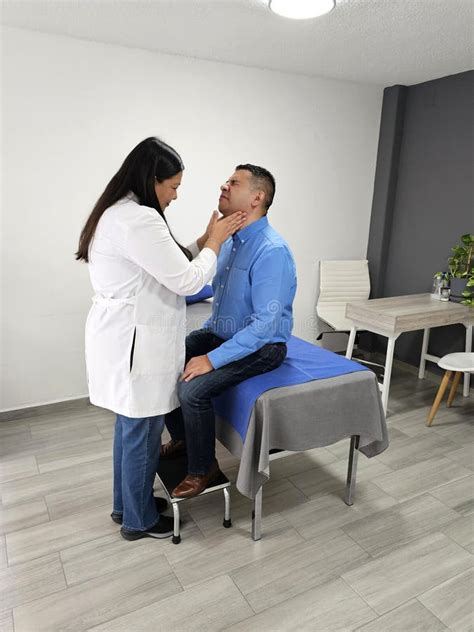 Latina Female Doctor Checks Dark Skinned Male Patient In Office For