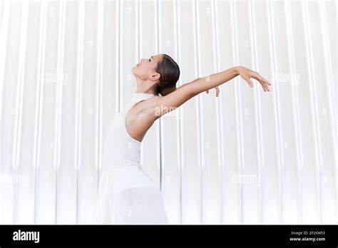 Side View Of Young Female Ballet Dancer In Pointe Shoes With Raised Leg