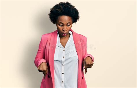 African American Woman With Afro Hair Wearing Business Jacket Pointing