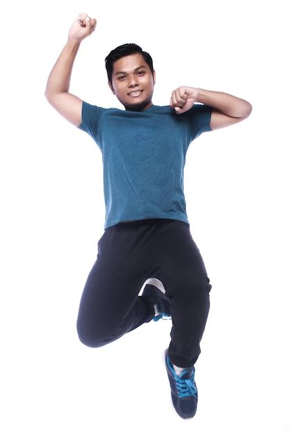 Premium Photo Portrait Of Young Man Jumping Against White Background