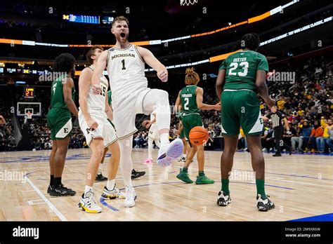 Michigan Center Hunter Dickinson 1 Reacts After A Dunk During The