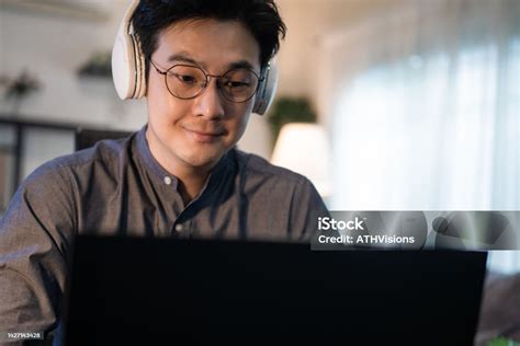 smiling developer computer programmer man working coding on laptop computer at home office