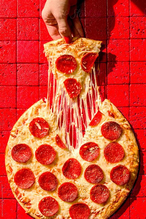 Pepperoni Pizza Cheese Pull By Stocksy Contributor Gabriel Lucido Stocksy