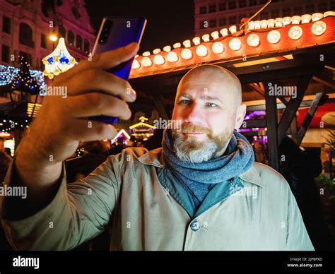 Adult Person Taking A Selfie Outdoor On A City Christmas Market At