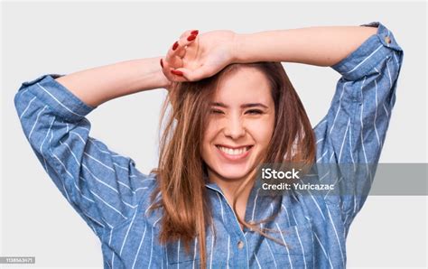 재미 있는 젊은 여 자가 아침에 재미 있는 얼굴을 만드는 캐주얼 블루 셔츠를 입고의 초상화를 닫습니다 긍정적 인 소녀는 흰색