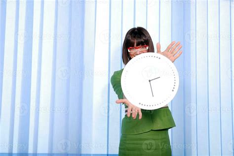 A Pretty Business Woman Hiding Behind A Clock Stock Photo At Vecteezy
