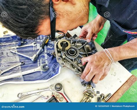 Engineering Student Learning To Disassemble The 4 Cylinder Diesel