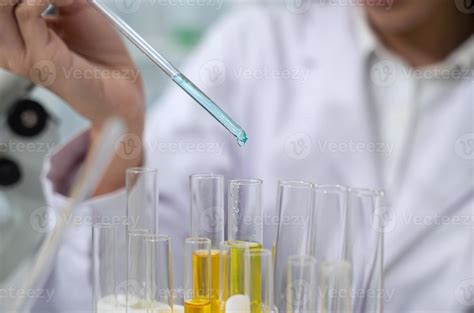 Scientist Dropping Liquid Into Test Tube Sample In Chemical Laboratory 22958970 Stock Photo At