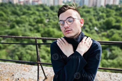 Dreamer Stylish Macho Man In Black Golf And Glasses Posed On The Roof