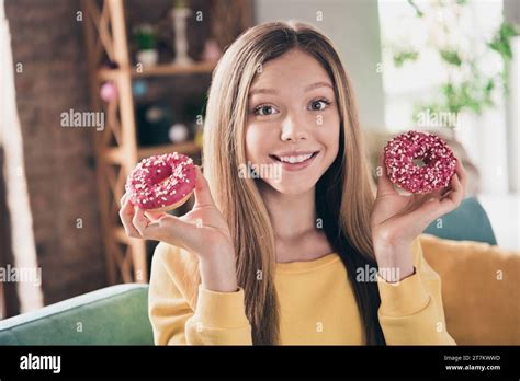 Portrait Of Cheerful Funky Caucasian Teenage Girl Hold Two Donuts