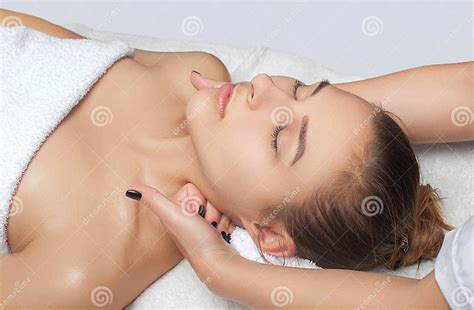 Masseur Makes A Relaxing Massage On The Face Neck Shoulders And