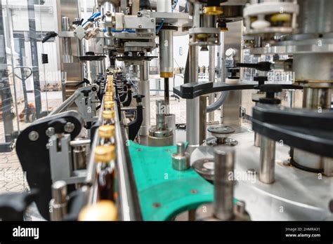 Conveyor Carries Glass Bottles Of Luxury Cognac In Workshop Stock Photo