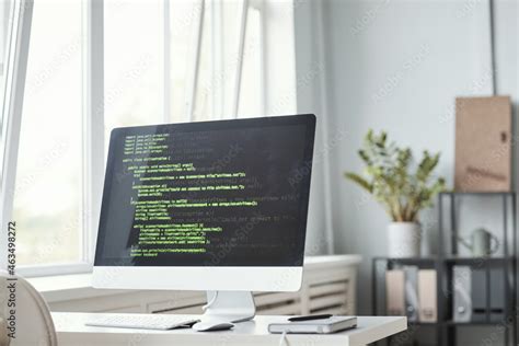 Background Image Of Pc Screen With Green Code Lines On Desk In Software Development Office