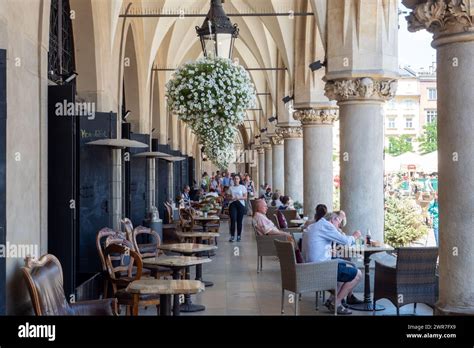 People Sitting At Tables In A Restaurant Under The Arcades In