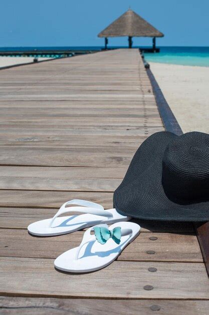 Premium Photo A Hat And Sandals On A Dock With A Hat On It
