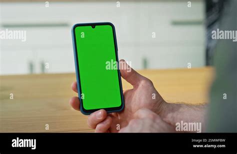 Man Scrolling Chroma Key Mobile Phone Making Online Purchases At Home