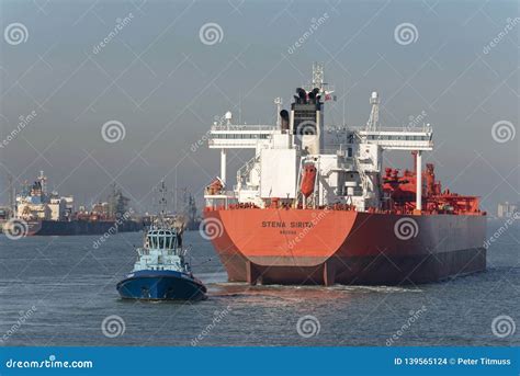 Tug With Line Attached To The Stern Of An Oil Tanker Editorial Photo