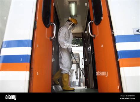 Health Workers Spraying Disinfectant Liquid In The Train Interior At