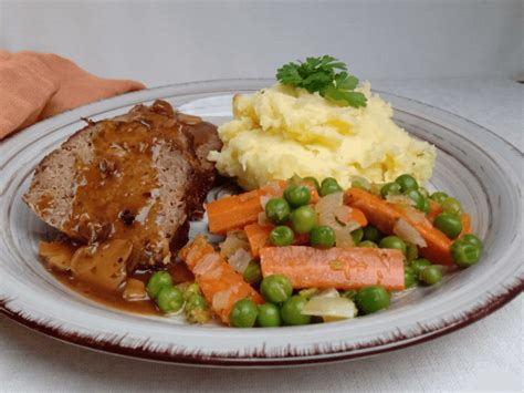 Homemade Meatloaf With Gravy Mashed Potatoes And Carrots And Peas