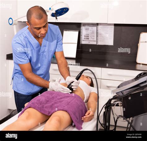 Cosmetologist Performing Ultrasound Cavitation Body Procedure For