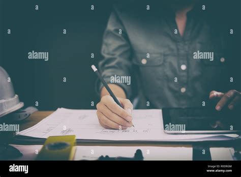 Architect Using Tablet Engineer Working On House Blueprint Of Real Estate Project At Workplace