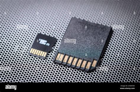 Close Up Of Secure Digital SD Flash Memory And MicroSD Card On Metallic Surface Size Comparison