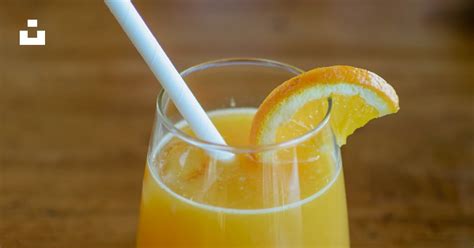 빨대가 들어있는 오렌지 주스 한 잔 사진 Unsplash의 무료 즙 이미지