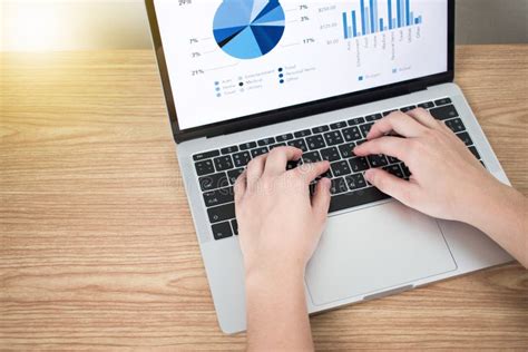 Picture Of The Data Graph In A Laptop Computer On A Brown Wood Desk
