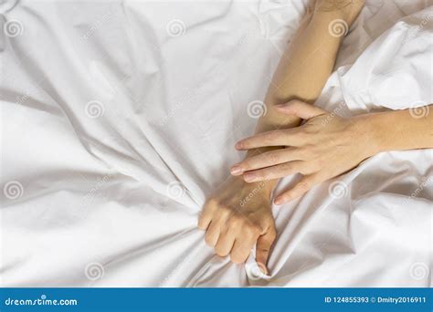 Couple Hands Pulling White Sheets In Ecstasy Orgasm Concept Of