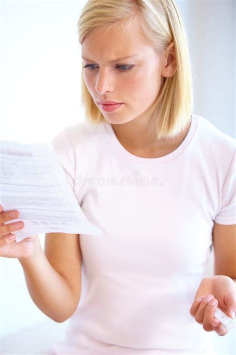 Reading The Instructions A Young Woman Reading About How To Use A