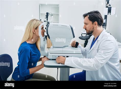 Experienced Ophthalmologist Man Using Automated Refractor For Vision